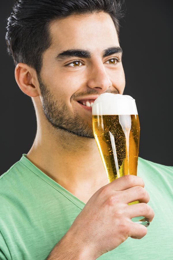 Young man drinking beer stock image. Image of cheers - 58605061