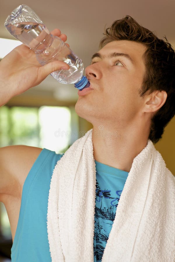 A Young Man Drinking a Bottle of Water Stock Image - Image of slim ...