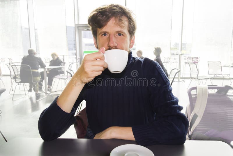 Young Man Drinking Coffee in a Cafe Stock Photo - Image of chair ... Young Man Drinking Coffee in a Cafe Stock Photo - Image of chair ...