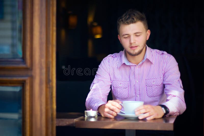 Young man drinking coffee stock image. Image of northern - 39274631 Young man drinking coffee stock image. Image of northern - 39274631