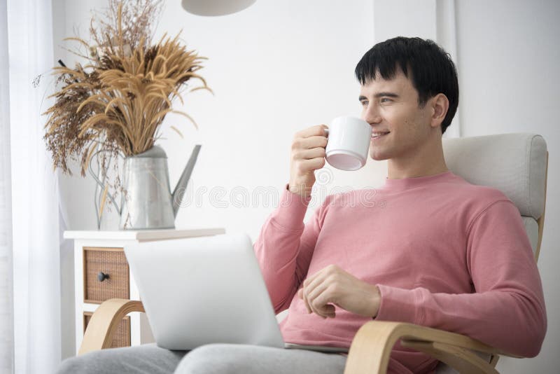 Young Man Drinking Coffee and Using Computer in the Morning Time Stock ...
