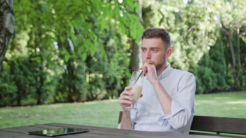 A Young Man Drinking Milkshake in the Park Stock Photo - Image of male ...