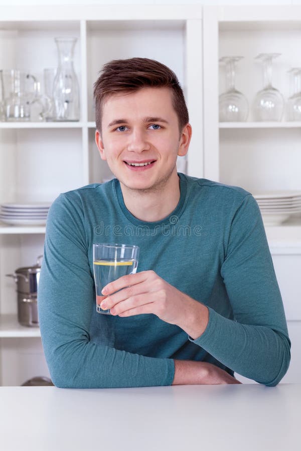 Young Man Drinking Refreshing Lemonade in His Kitchen Stock Image ...