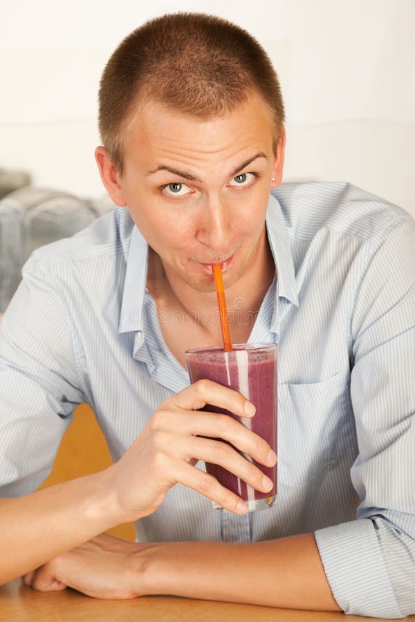 Young Man Drinking a Smoothie Stock Photo - Image of slurp, indoors ...