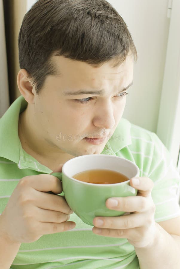 Young man drinking tea stock photo. Image of solitude - 18008302