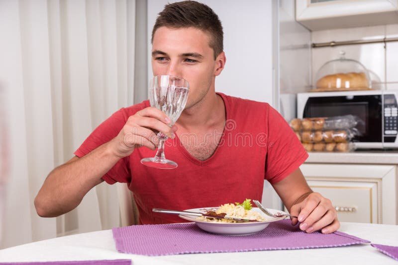 Young Man Drinking Water with Dinner Stock Photo - Image of alone ...