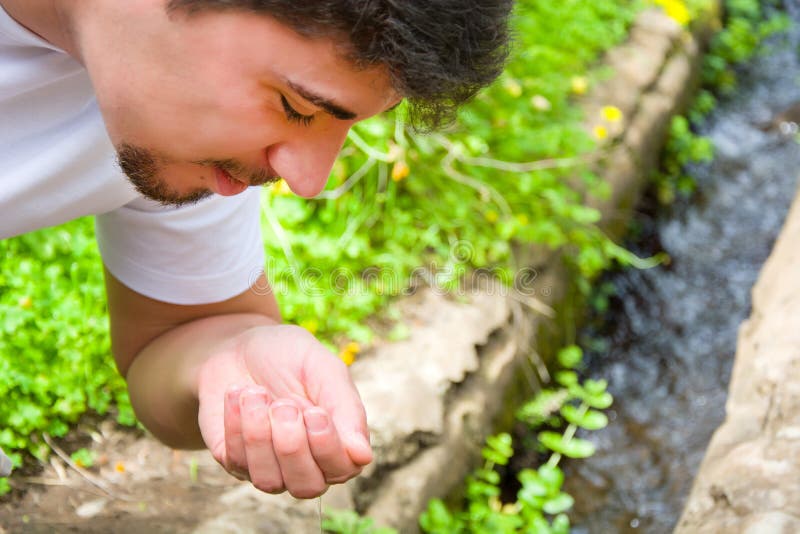 Young Man Drinking Water from a Stream Stock Image - Image of child ...