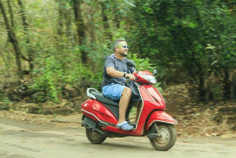 Young Man Drives a Red Motorcycle Stock Image - Image of blue, casual ...