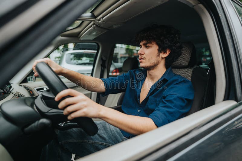 Young Man Driving Car with Focused Expression in Urban Setting Stock ...
