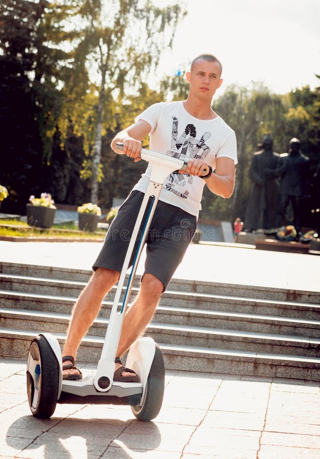 Young Man Driving on Segway in the Park. Stock Image - Image of ...