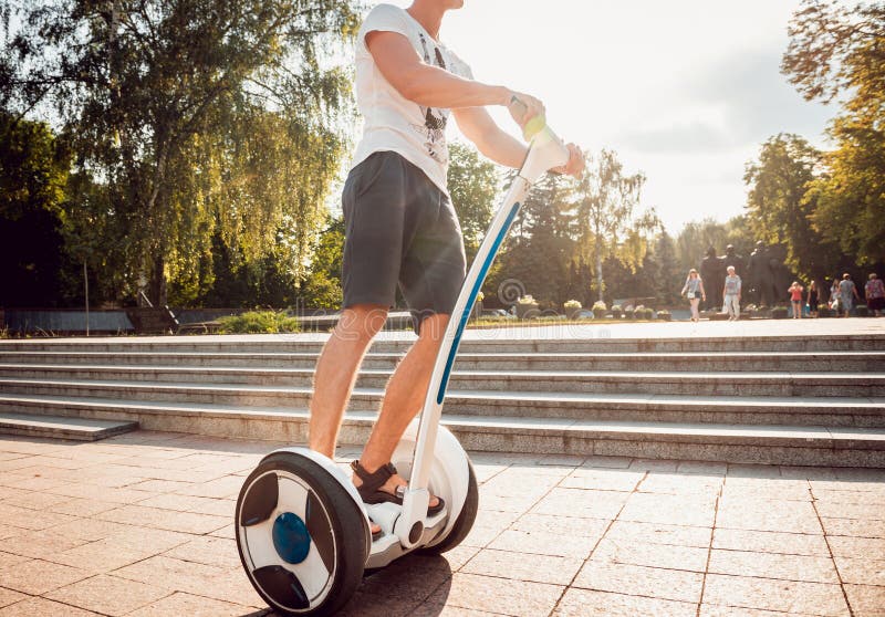 Young Man Driving on Segway in the Park. Stock Photo - Image of segway ...