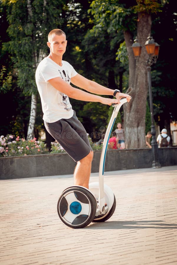 Young Man Driving on Segway in the Park. Stock Photo - Image of ...