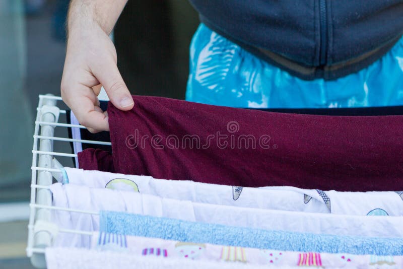 Young Man Drying Clothes after Laundry Stock Photo - Image of drying ...