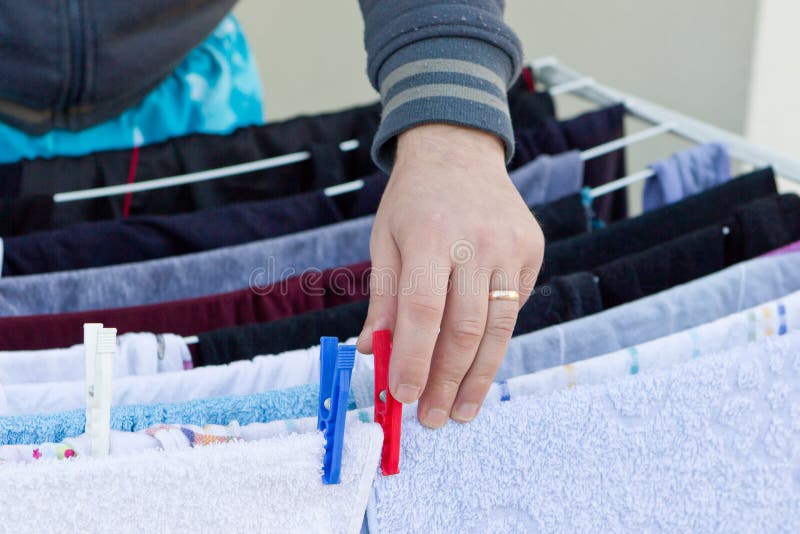 Young Man Drying Clothes After Laundry Stock Photo - Image of drying ...
