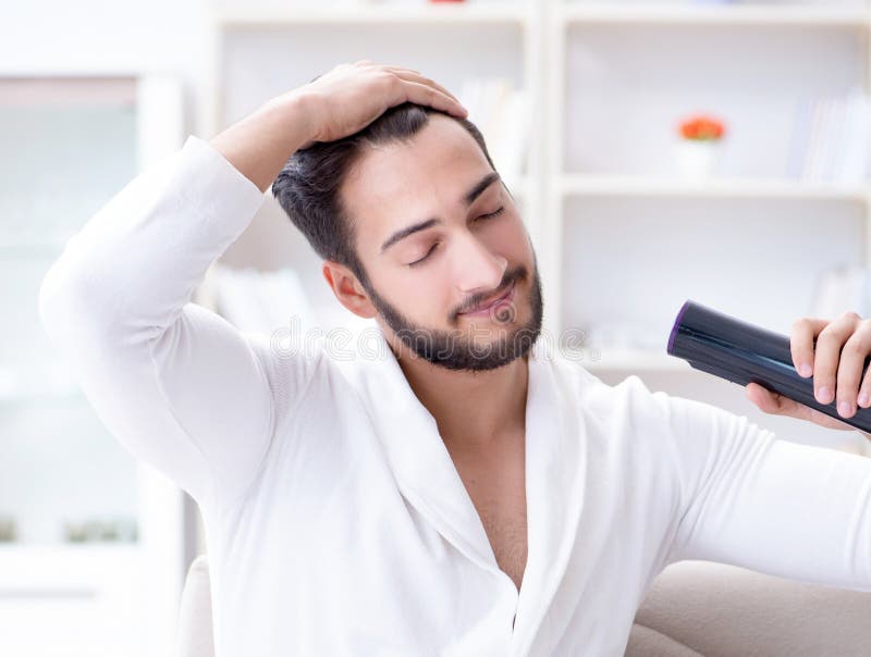 Young Man Drying Hair at Home with a Hair Dryer Blower Stock Image ...