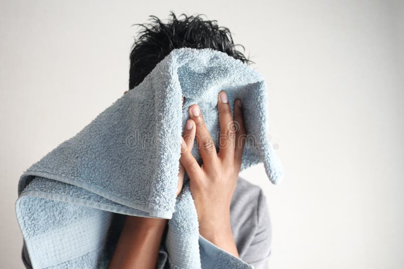 Young Man drying his face. stock photo. Image of people - 303336584