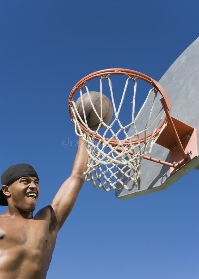 Young Man Dunking Basketball into Hoop Stock Photo - Image of energy ...