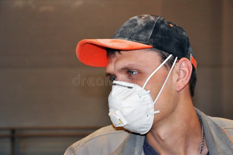 Young Man in a Dust Mask and Dusty Cap at Work Stock Photo - Image of ...