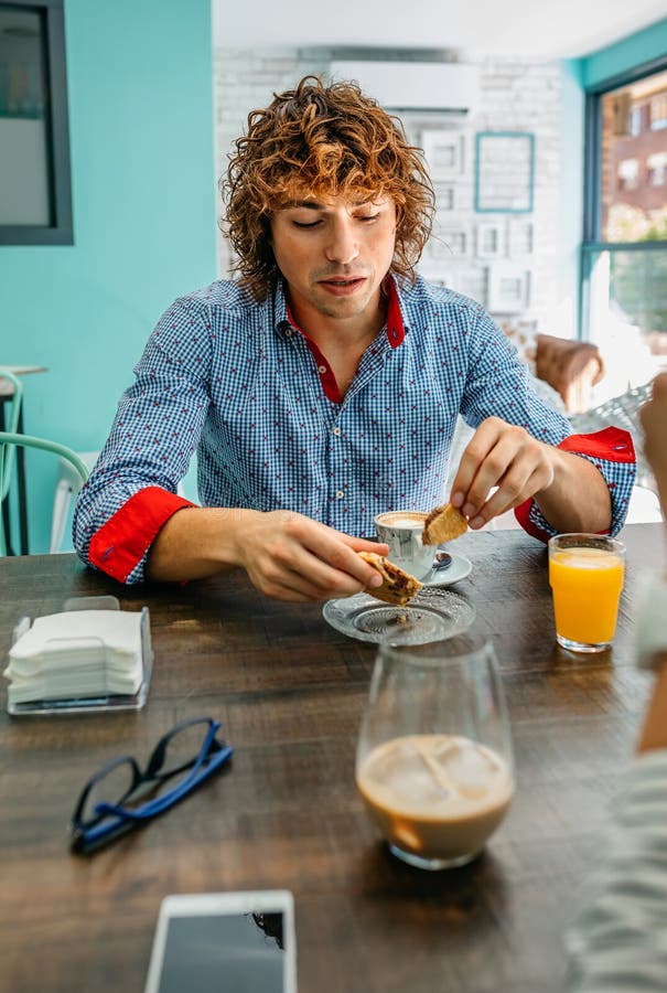 Young man eating breakfast stock photo. Image of food - 100323430