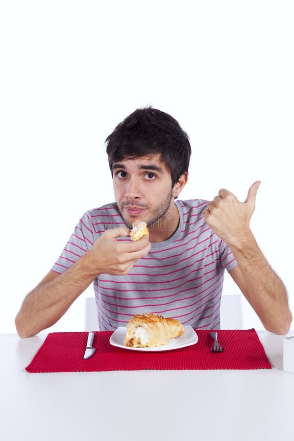 Young man eating a cake stock image. Image of lifestyle - 19036361