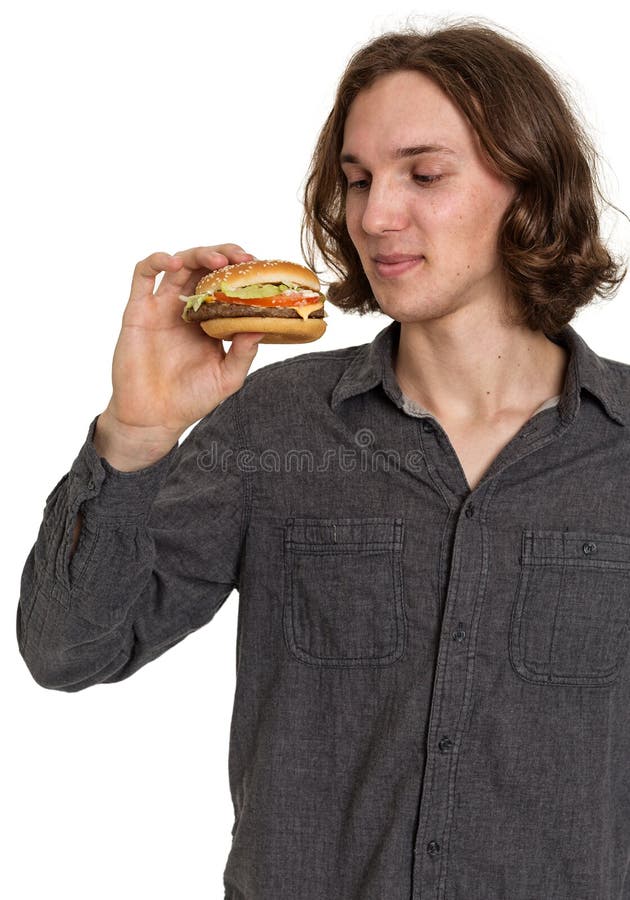 Young Man Eating a Hamburger Stock Photo - Image of dinner, vegetables ...