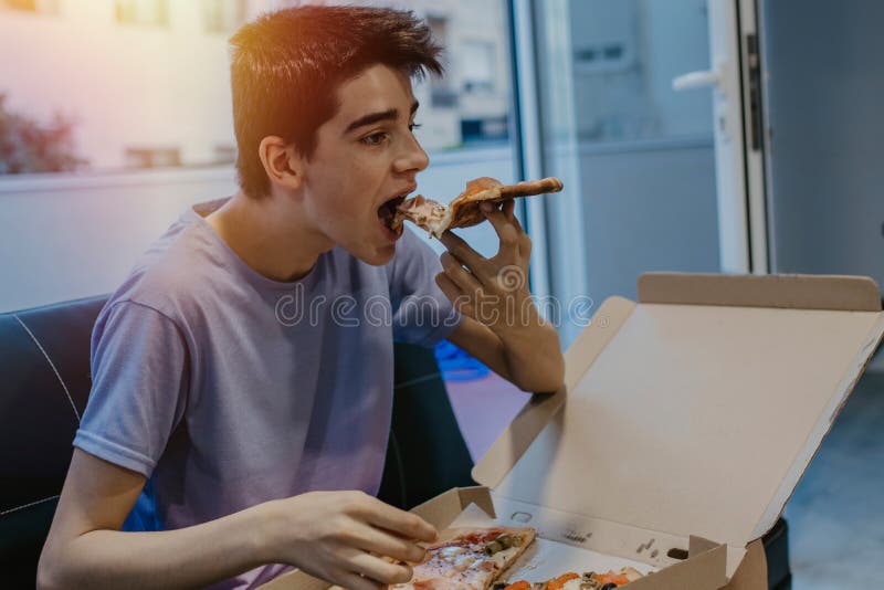 Young Man Eating Pizza at Home Stock Photo - Image of happy, hungry ...