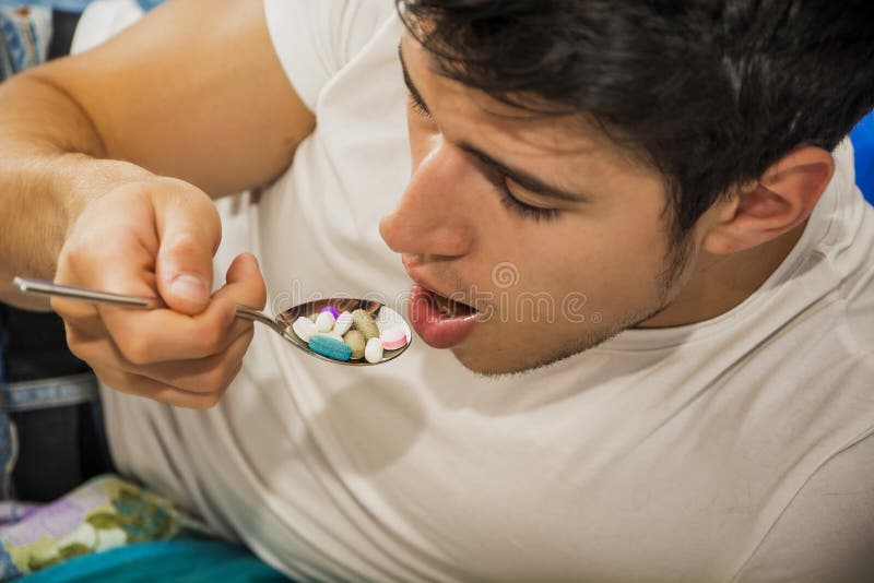 Young Man Eating a Spoon Full of Medicine Stock Image - Image of ...