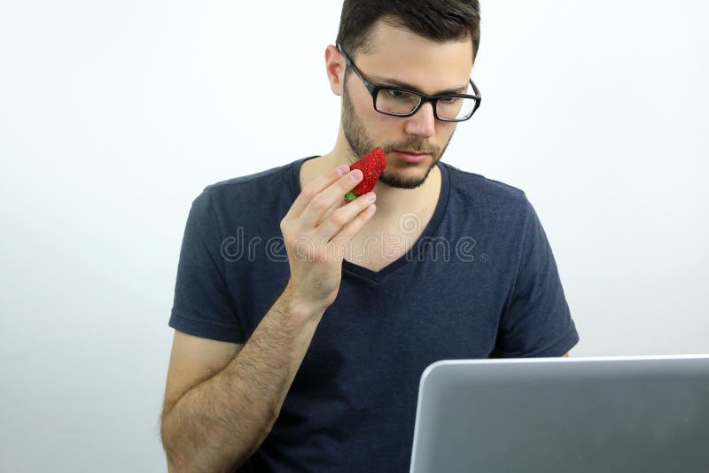 Young Man Eating a Strawberry Stock Photo - Image of food, business ...