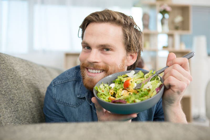 Young Man Eating Vegetarian Salad with Appetite Stock Photo - Image of ...