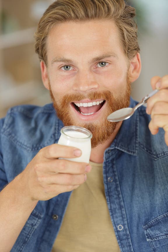 Young man eating yogurt stock photo. Image of food, milk - 288845690