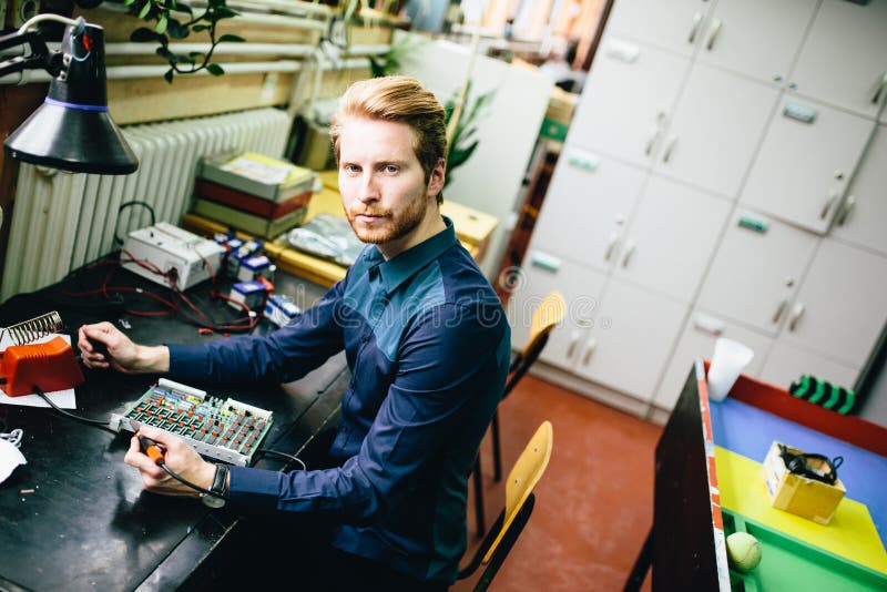 Young Man in Electronics Workshop Stock Image - Image of electricity ...