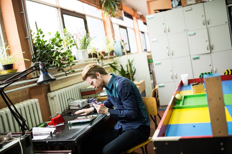 Young Man in Electronics Workshop Stock Image - Image of technology ...