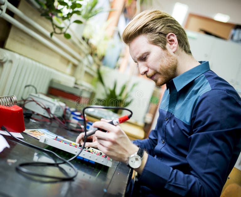 Young Man in Electronics Workshop Stock Photo - Image of technician ...