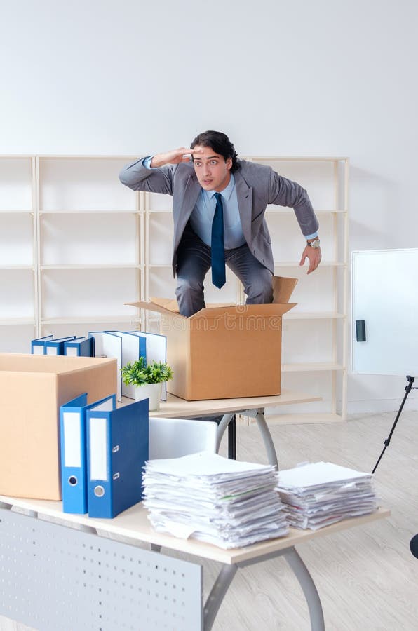 The Young Man Employee with Boxes in the Office Stock Photo - Image of ...