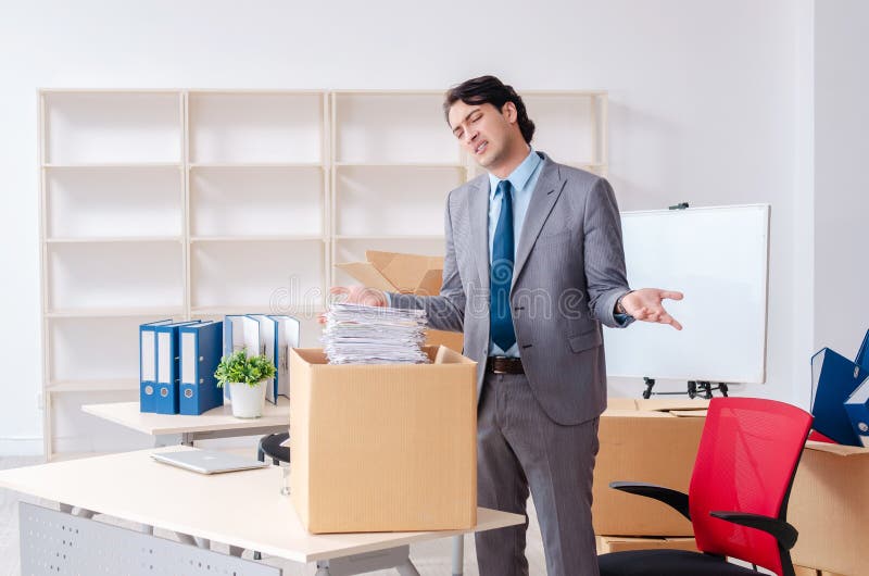 The Young Man Employee with Boxes in the Office Stock Photo - Image of ...