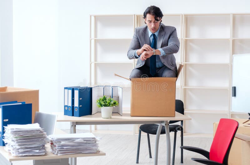 The Young Man Employee with Boxes in the Office Stock Image - Image of ...