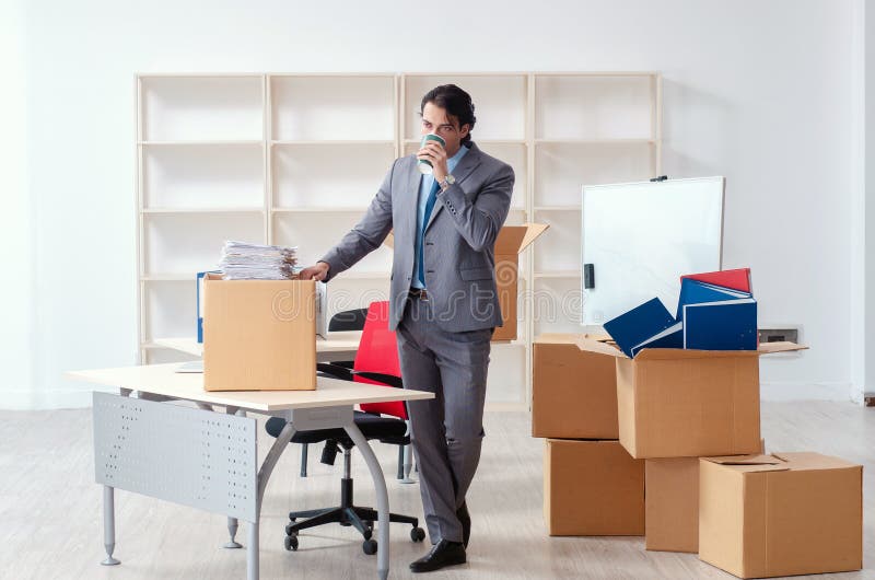 The Young Man Employee with Boxes in the Office Stock Photo - Image of ...
