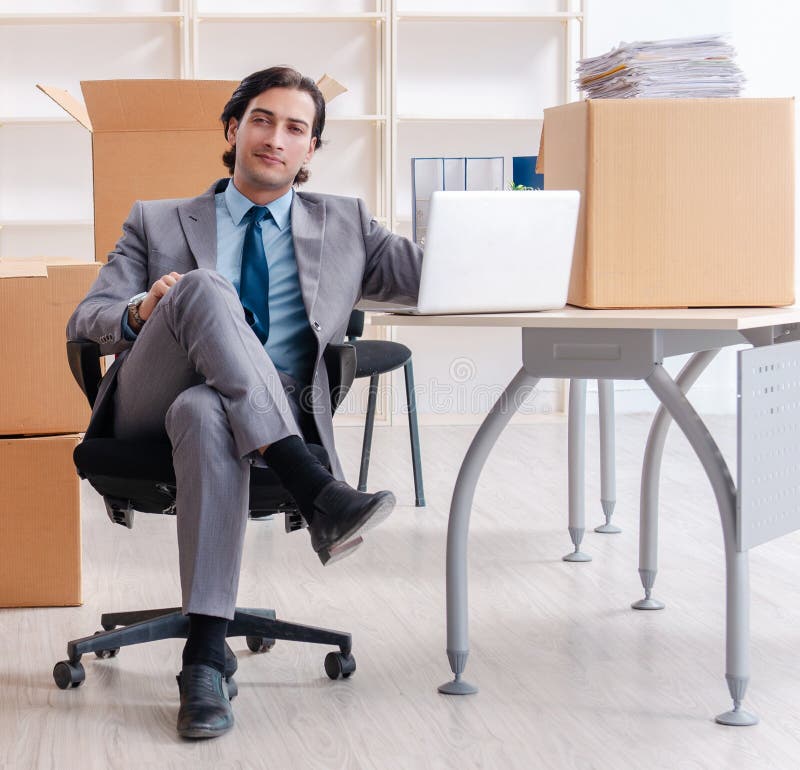 Young Man Employee with Boxes in the Office Stock Photo - Image of ...