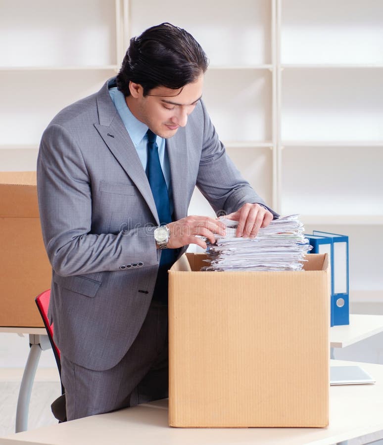Young Man Employee with Boxes in the Office Stock Photo - Image of ...