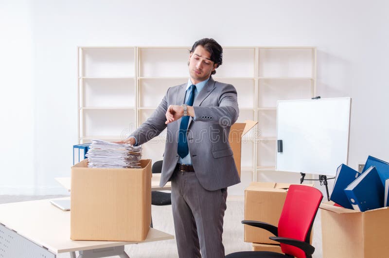 The Young Man Employee with Boxes in the Office Stock Image - Image of ...