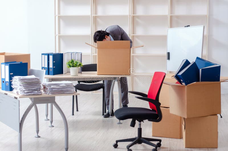 The Young Man Employee with Boxes in the Office Stock Photo - Image of ...