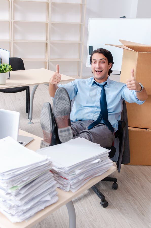 The Young Man Employee with Boxes in the Office Stock Photo - Image of ...
