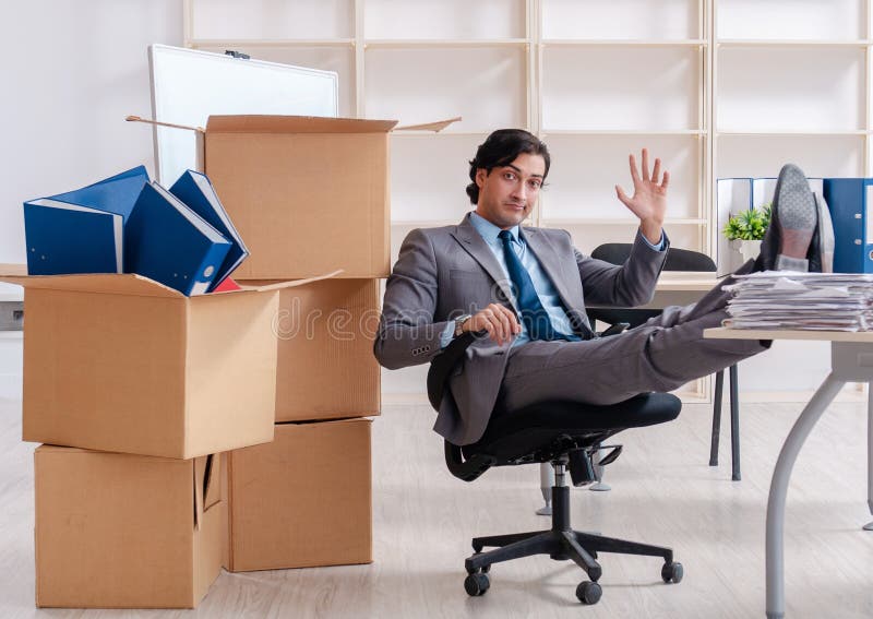 Young Man Employee with Boxes in the Office Stock Photo - Image of ...
