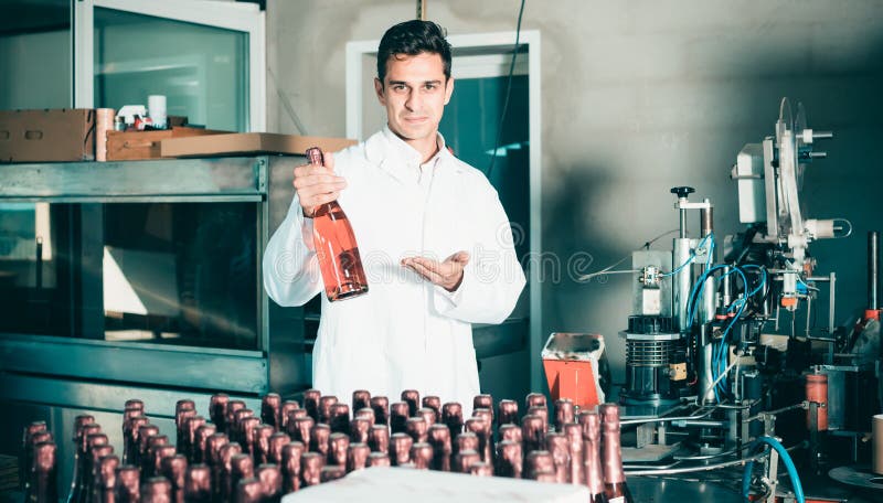 Young Man Employee Standing in Final Section of Wine Production Stock ...