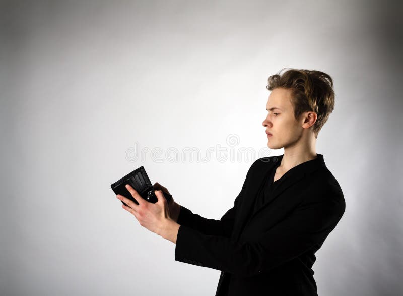 Young man and empty wallet stock photo. Image of bankrupt - 141750598