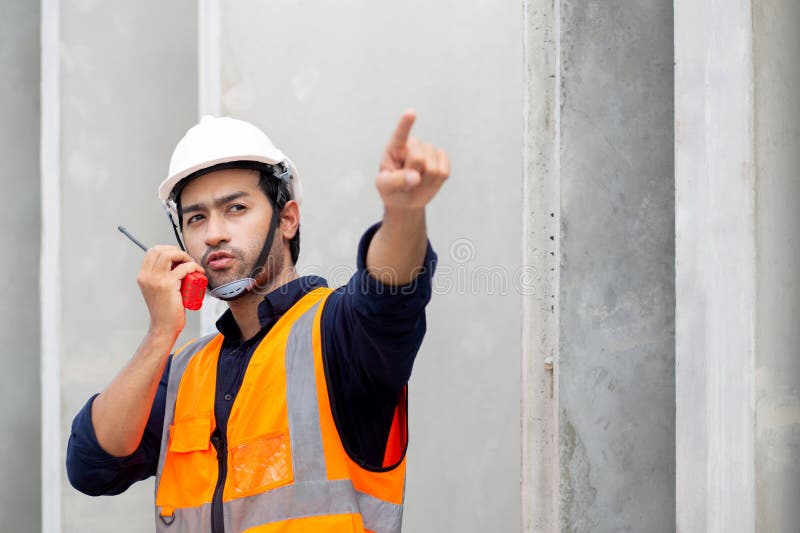 Young Man Engineer Using Radio Command with Worker in Construction Site ...