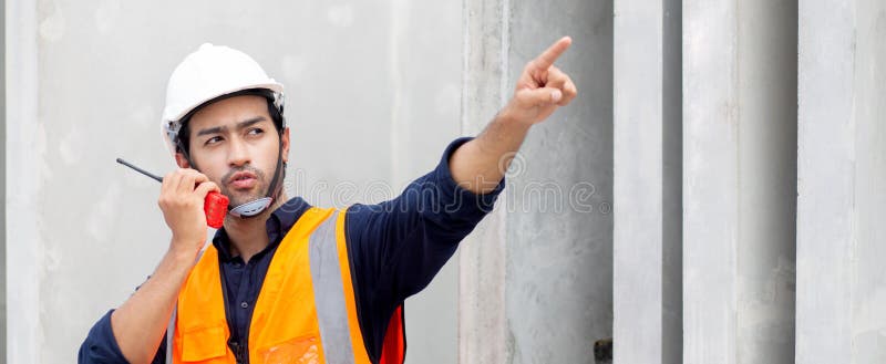 Young Man Engineer Using Radio Command with Worker in Construction Site ...