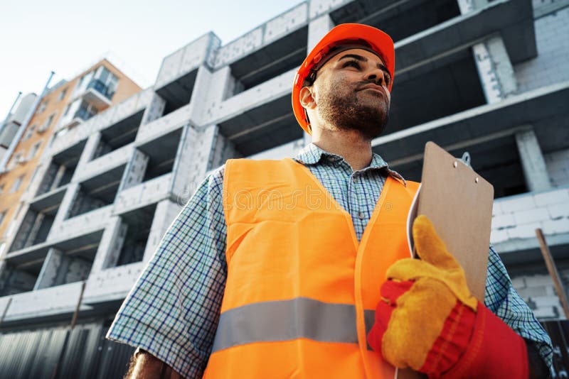 Young Man Engineer in Workwear Standing in Construction Site with ...