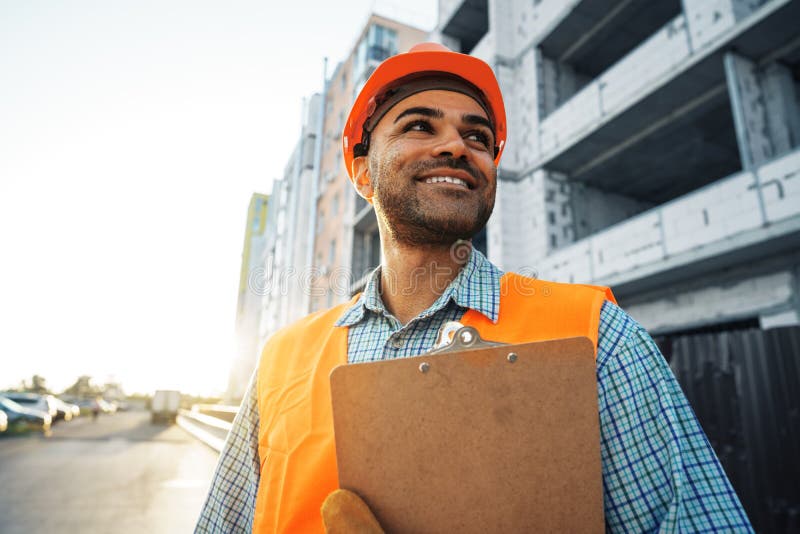 Young Man Engineer in Workwear Standing in Construction Site with ...