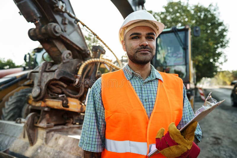 Young Man Engineer in Workwear Standing in Construction Site with ...